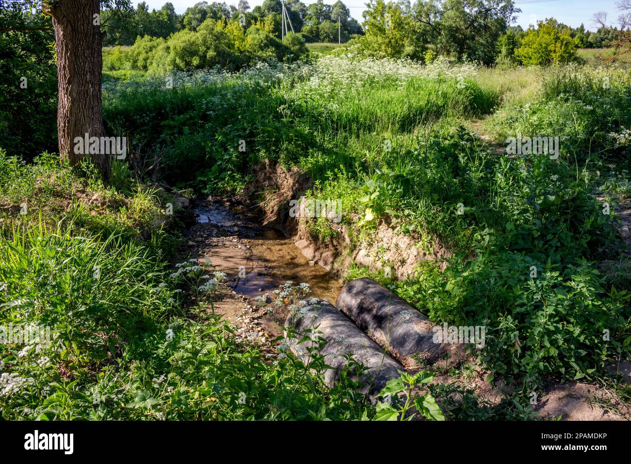 Water flow through water pipes in nature Stock Photo - Alamy