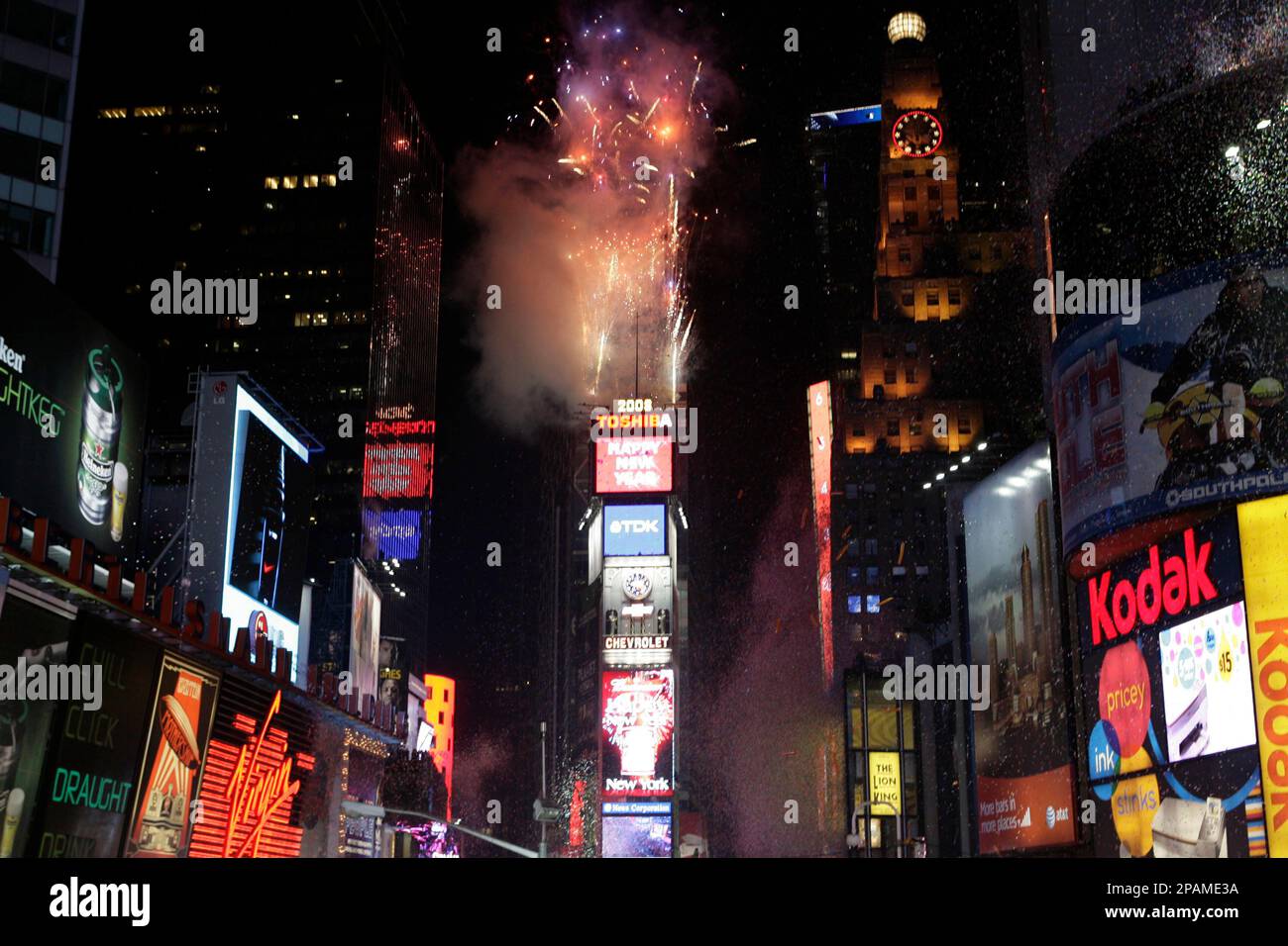 Fireworks erupt from a building at the stroke of midnight during the ...
