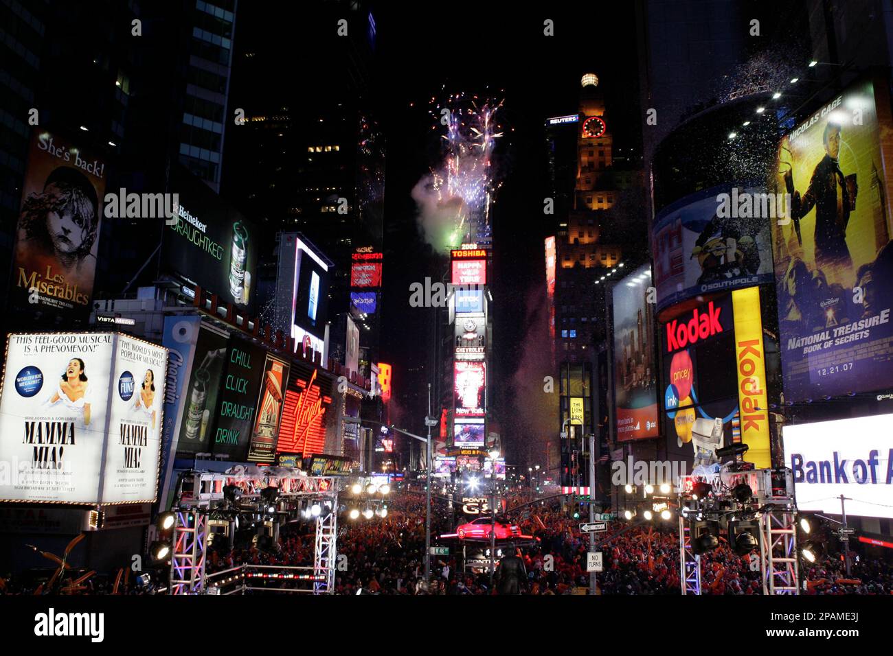 Fireworks erupt from a building at the stroke of midnight during the ...
