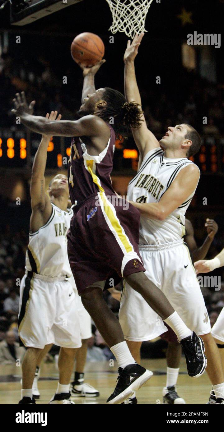 Iona forward Gary Springer, center, shoots around the reach of ...