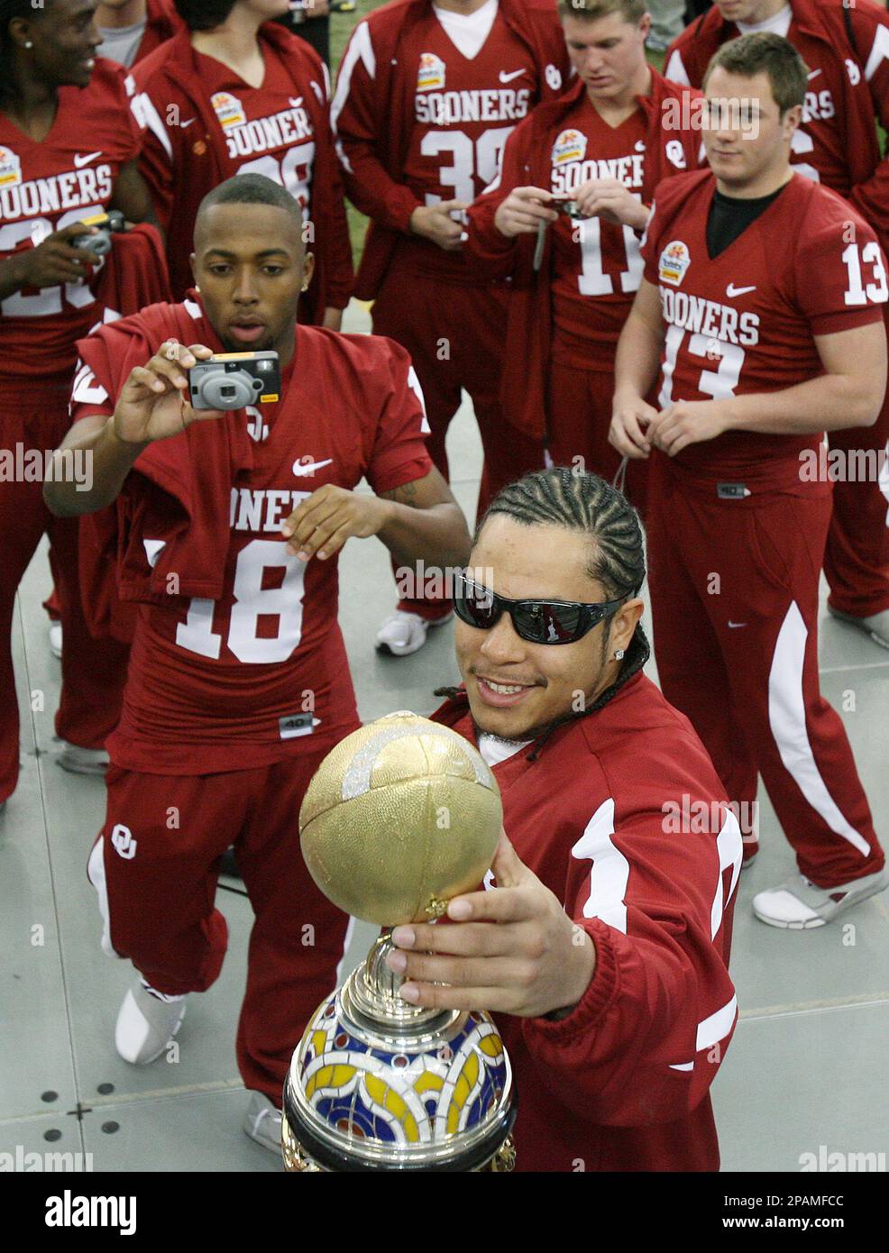 Oklahoma fullback Ian Pleasant touches the Fiesta Bowl trophy while ...