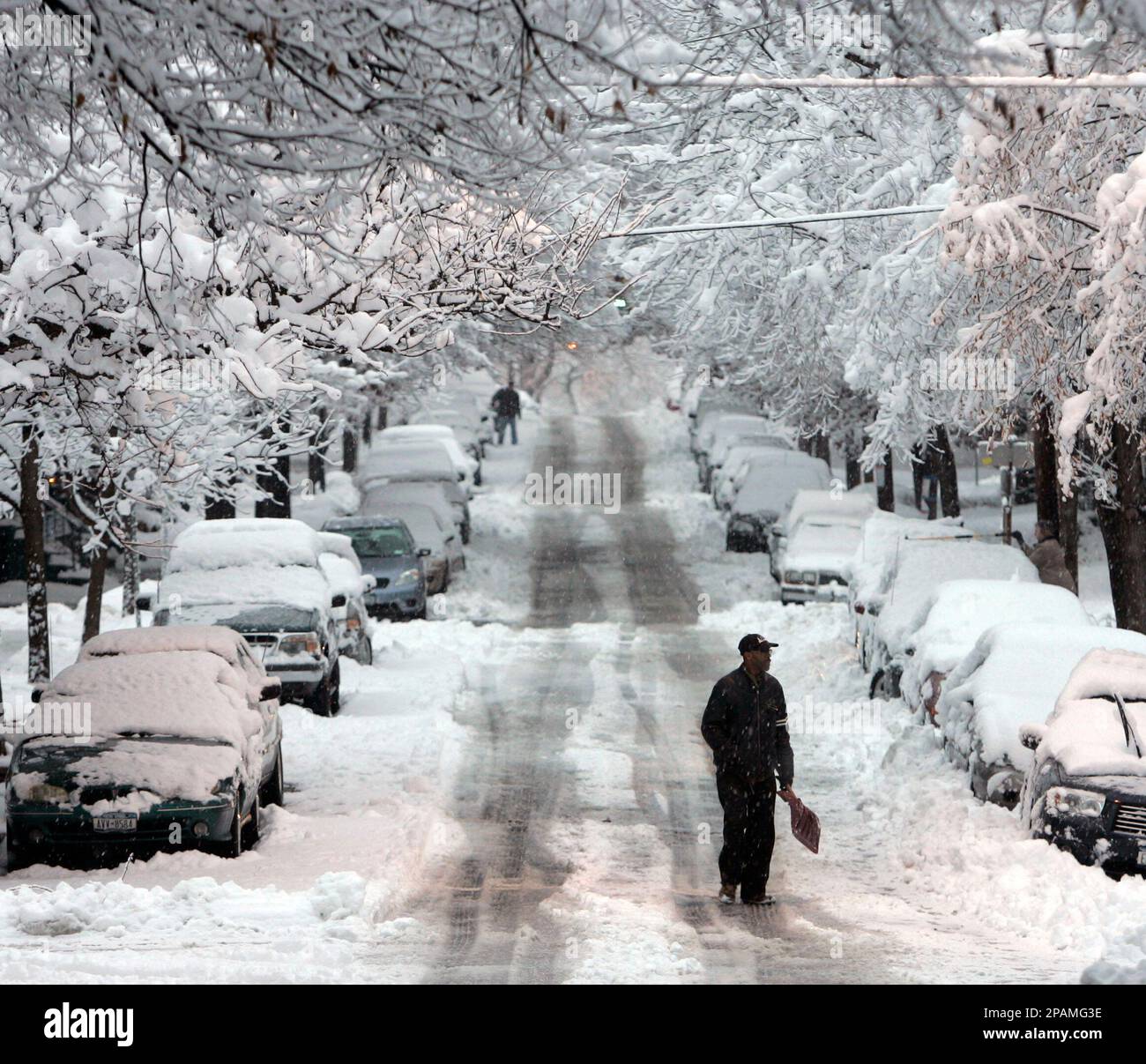 Tommy Arner carries a snow shovel in Albany, N.Y., Monday, Dec. 31 ...