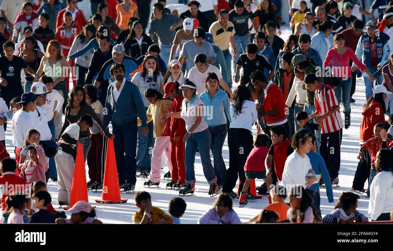 Mexican ice skaters make their way around an outdoor ice rink in Mexico ...