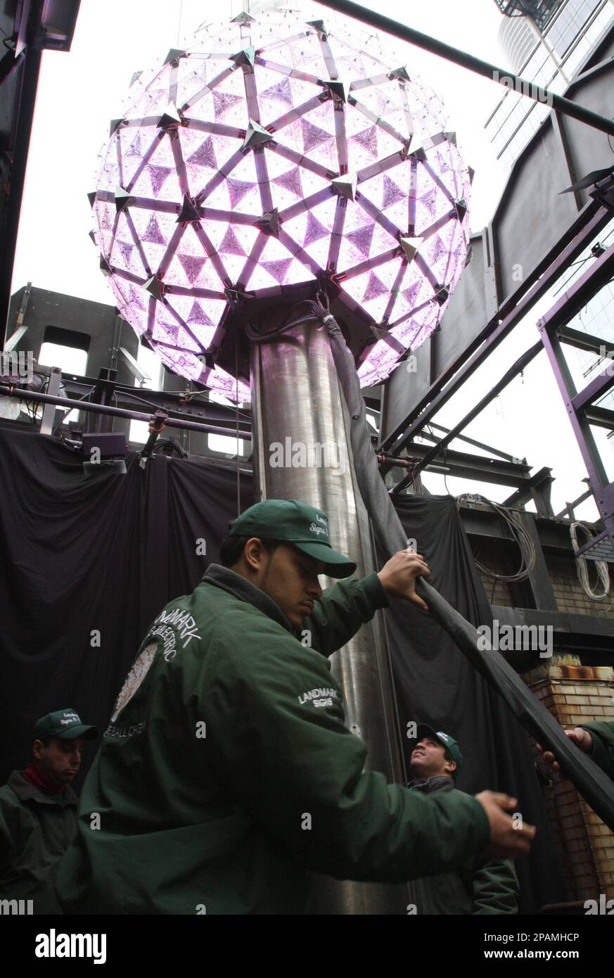 Workers guide cables as the new Times Square New Year's Eve ball makes ...