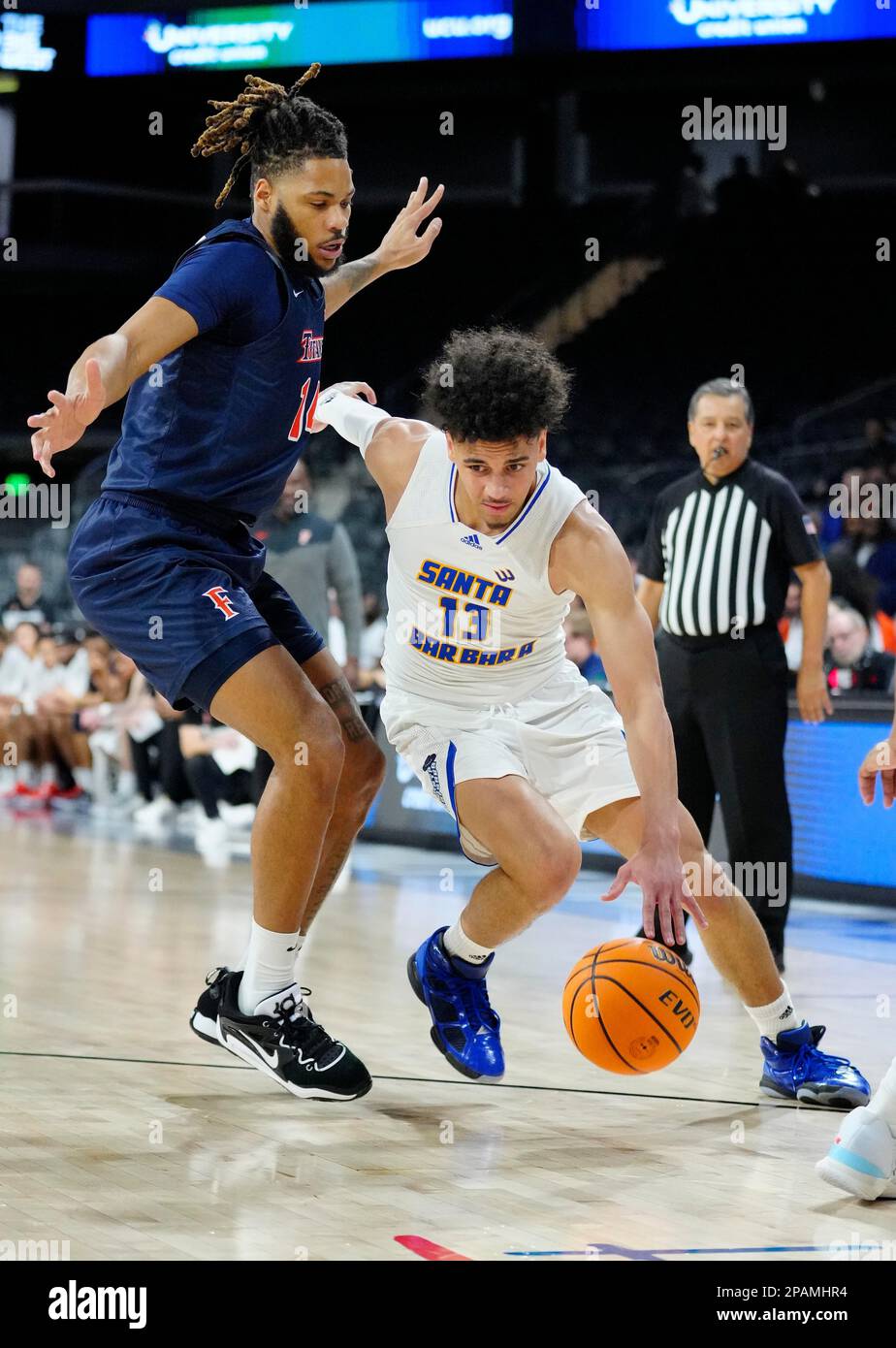 UC Santa Barbara guard Ajay Mitchell (13) drives past Cal State ...