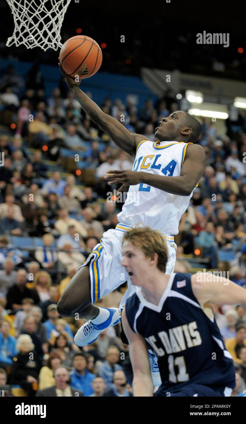 UCLA's Darren Collison goes up for a shot as UC Davis Mark Payne guards ...