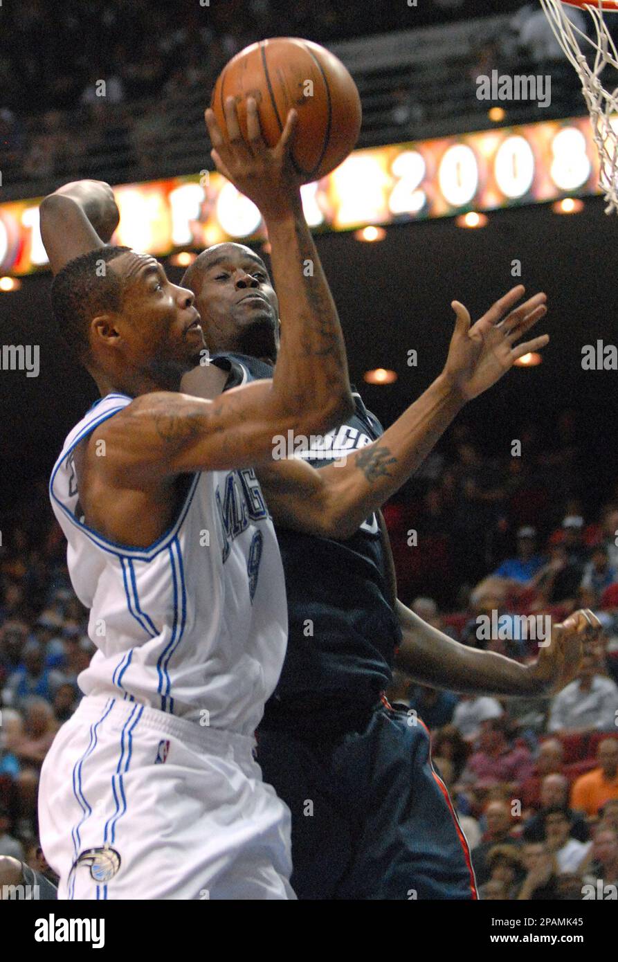 Orlando Magic forward Rashard Lewis, left, goes up for a shot as ...