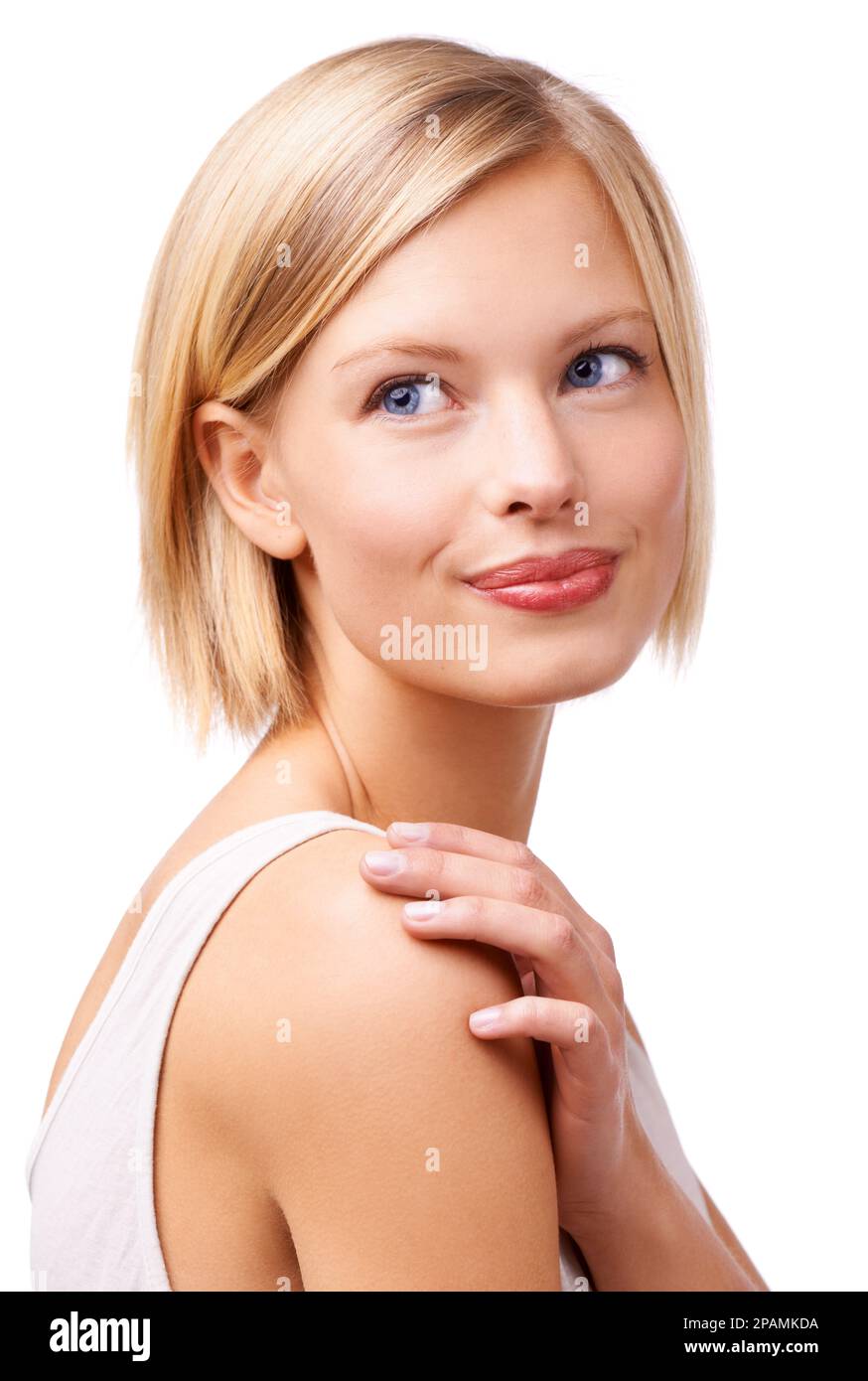 Playing it coy for the boys. Studio shot of a gorgeous young blond ...