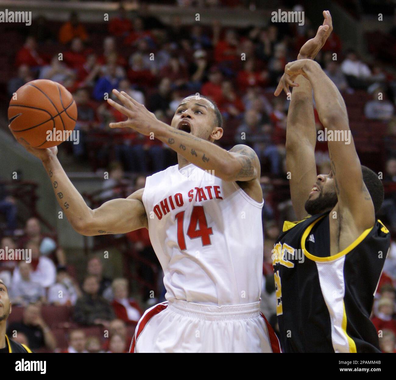 Ohio State's Jamar Butler, left, shoots over UMBC's Cavell Johnson ...