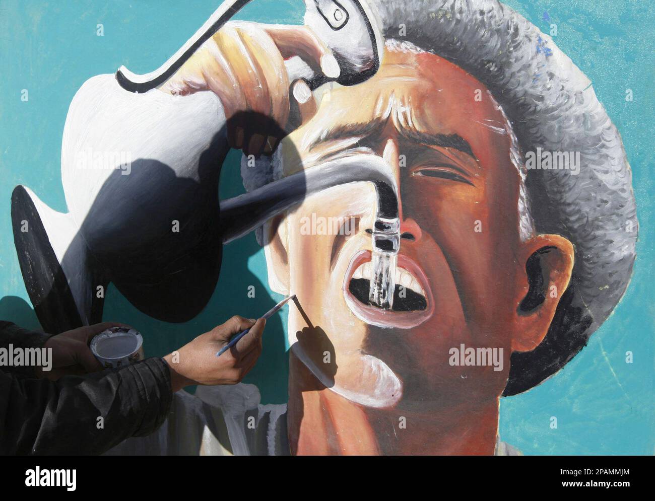 Afghan painter Zabi Ullah's shadow is reflected on a portrait in Kabul ...