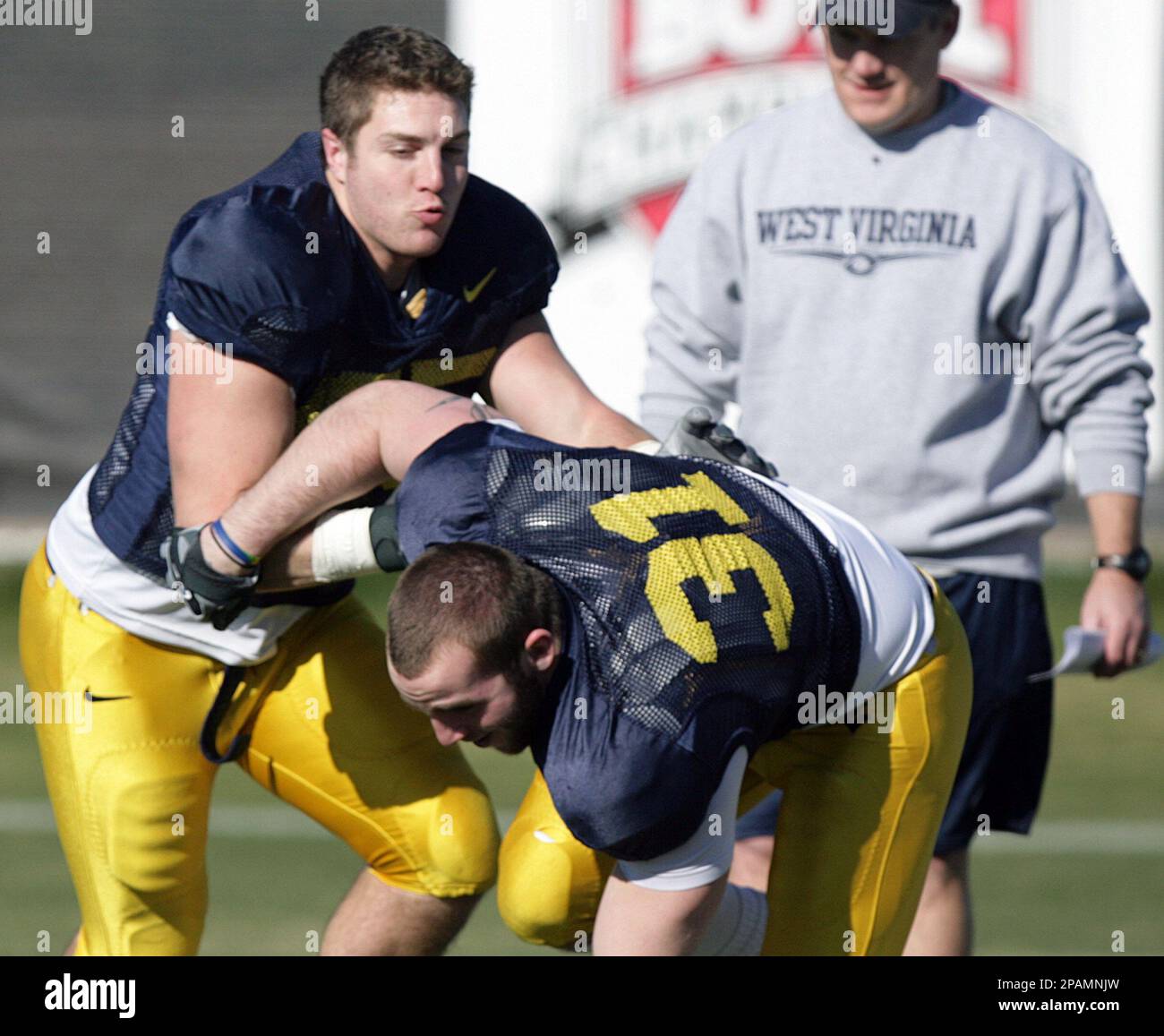 West Virginia linebackers Bobby Hathaway, left, and Pat Lazear, center ...
