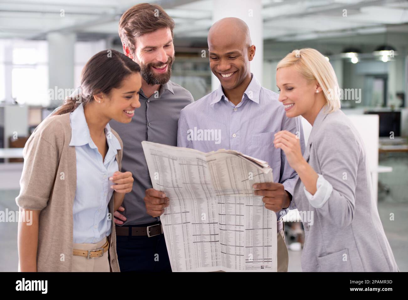 Keeping up to date with the competition. a group of work colleagues ...