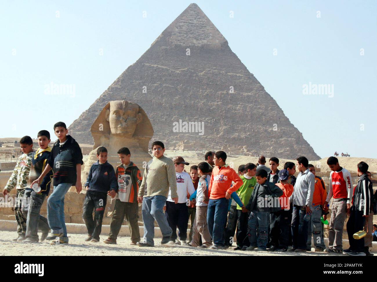 Egyptian school pupils march in front of the site of the Great Pyramids ...