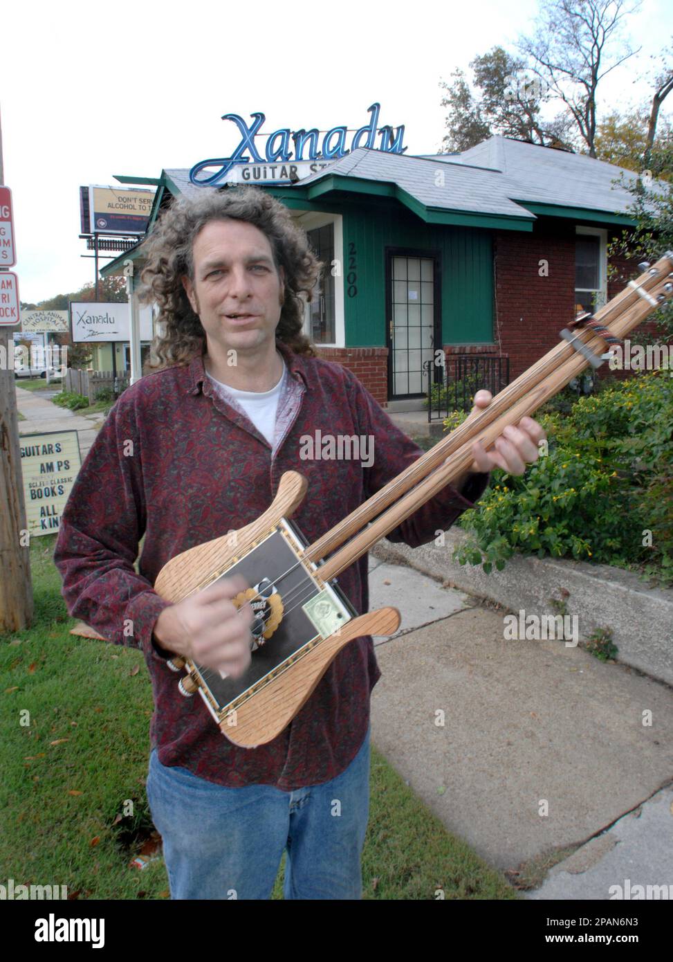 John Lowe plays one of his four string cigar box guitars, the Lowebow ...
