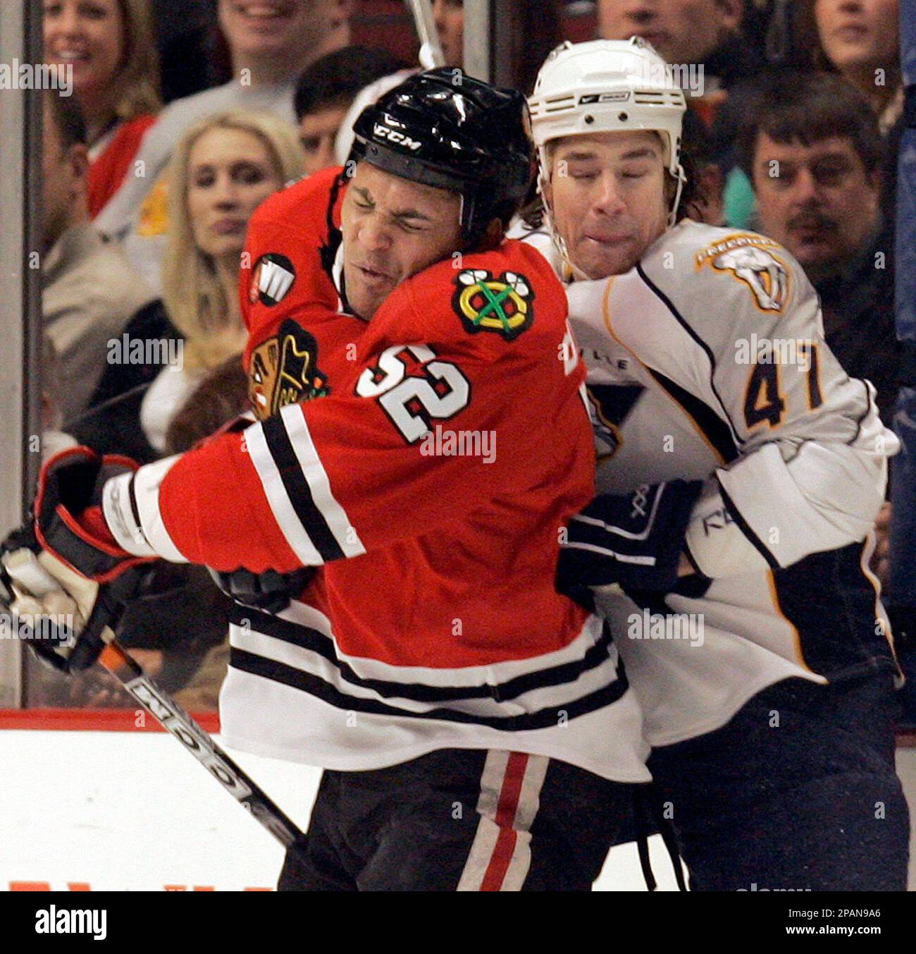 Chicago Blackhawks' Dustin Byfuglien, left, is checked by Nashville ...