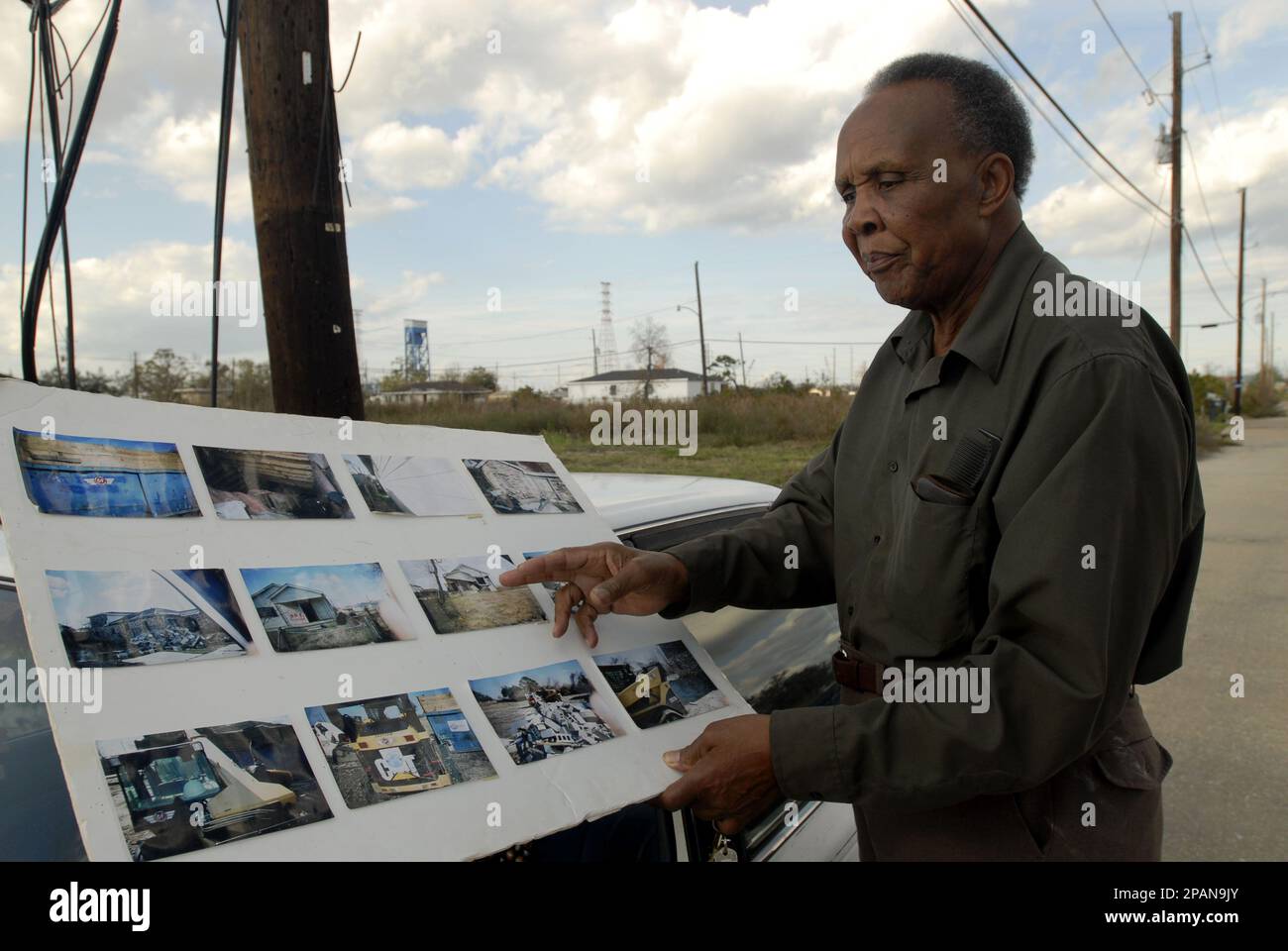 The Rev. Louis Adams looks at photos of his church near the empty lot ...
