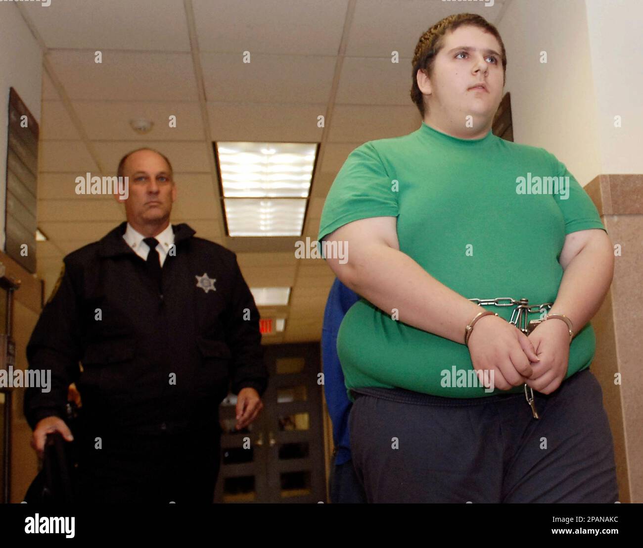 ** FILE ** Dillon Cossey, 14, is led into the courtroom at the ...