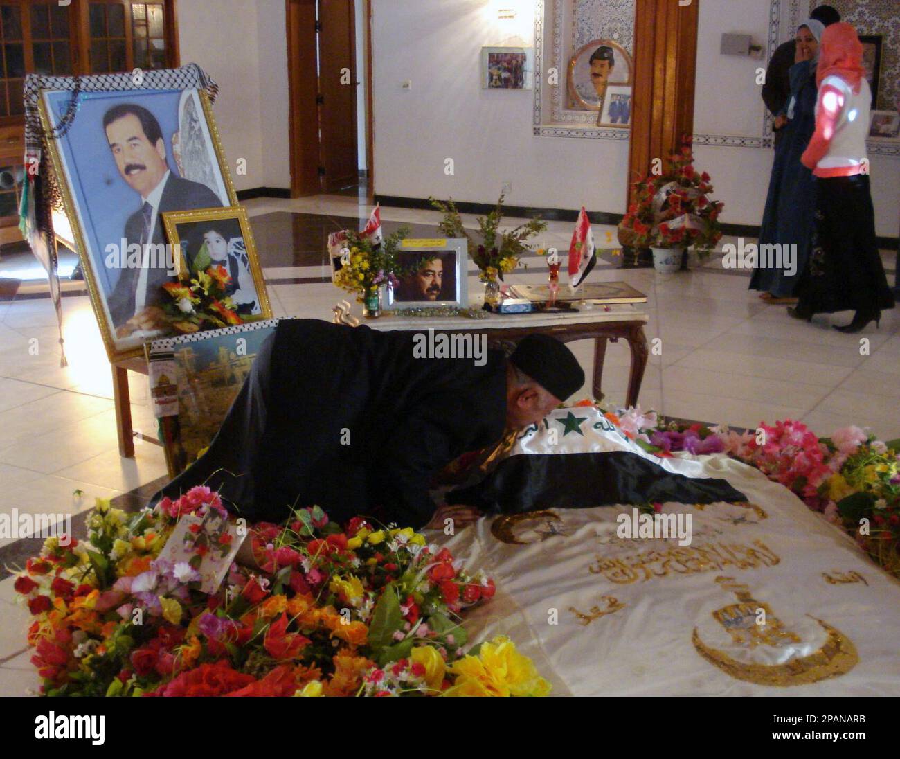An Iraqi man prays at the tomb of former national leader, Saddam ...