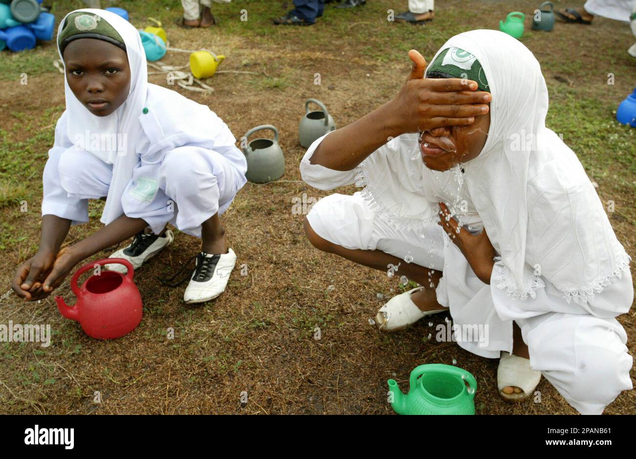 Hadiza Ahmed, left, and Sa'adatu Ousman perform ablutions before ...