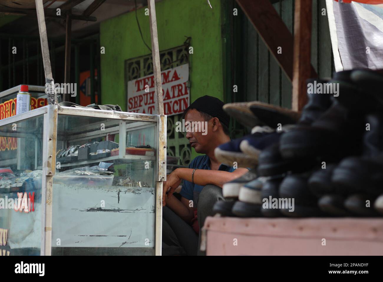 a watch repairman was waiting for a customer at his little stand by the ...