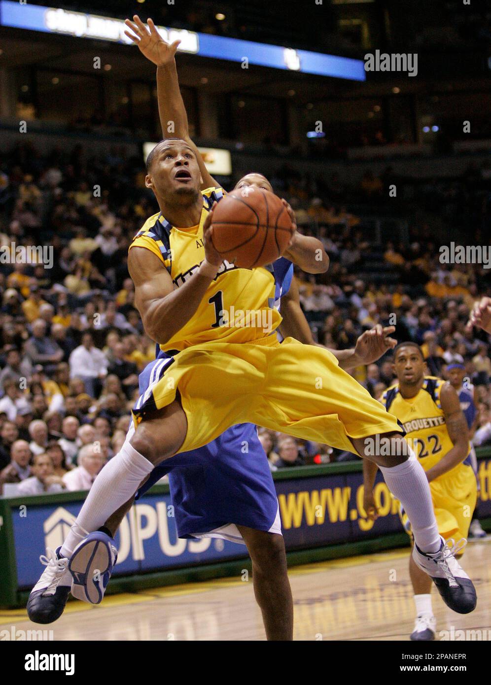 Marquette's Dominic James puts up a shot in front of IPFW's Jakari ...