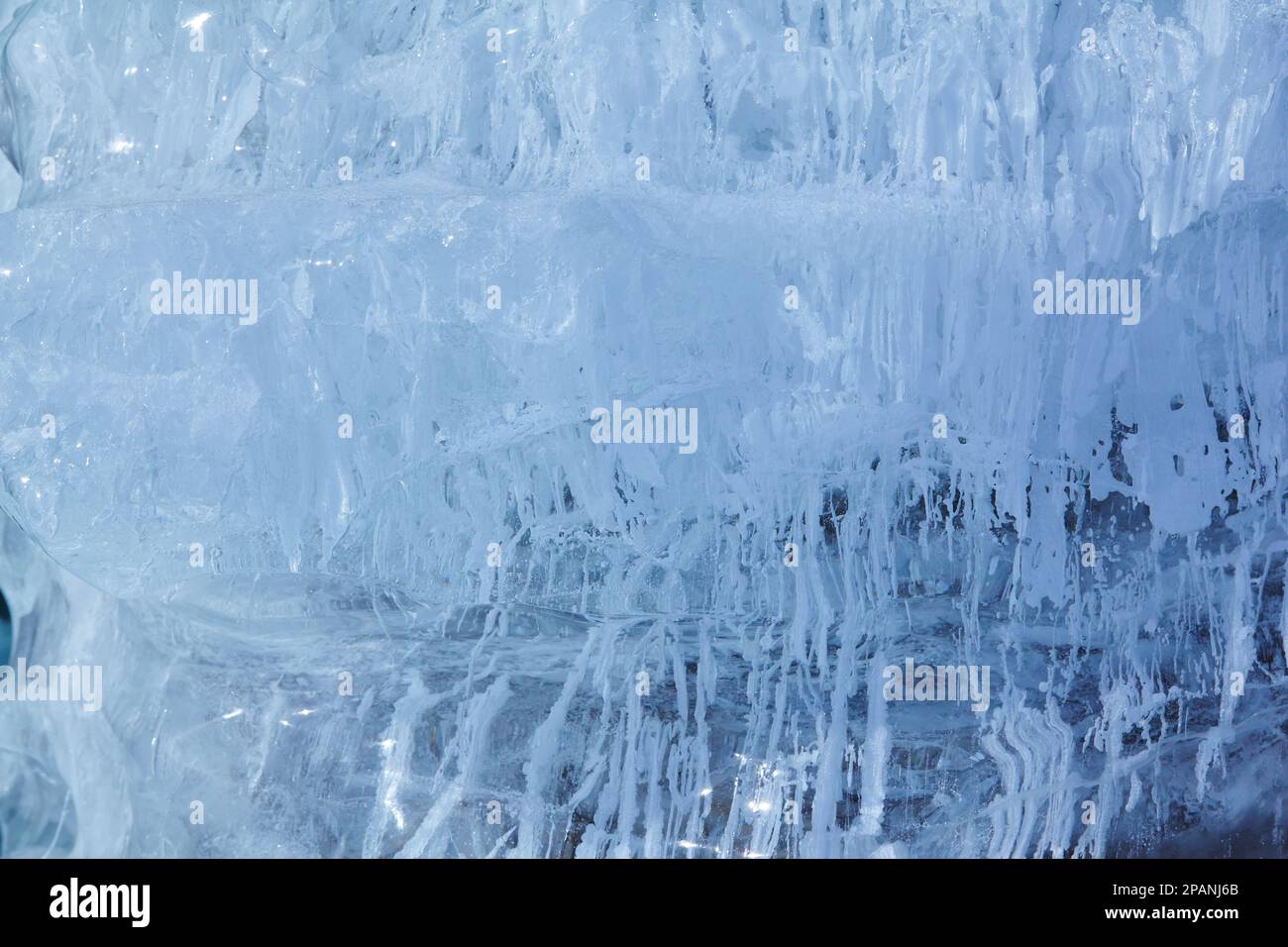 Texture of winter ice on a stone cliff. Blue natural ice background ...