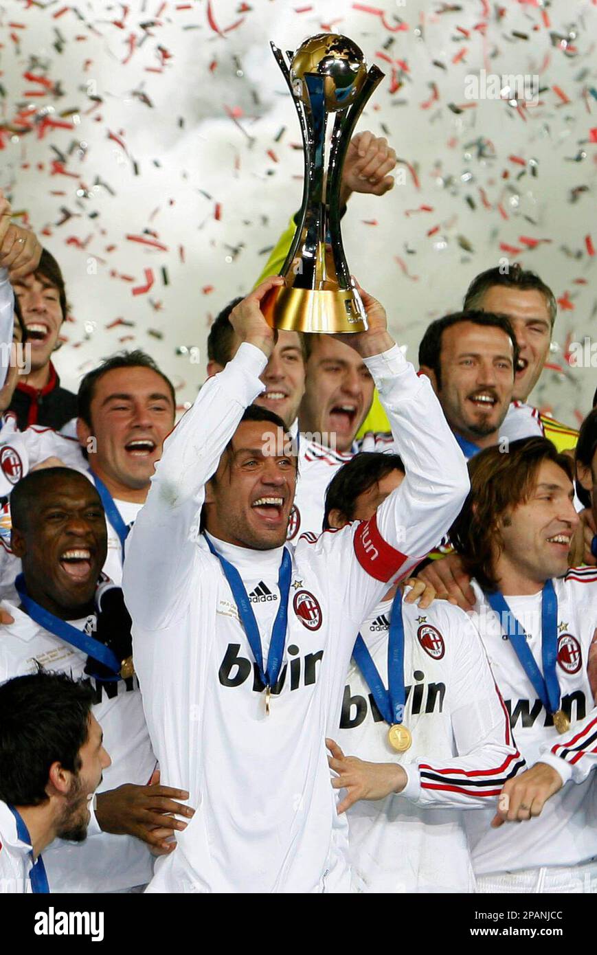 Captain Paolo Maldini holds up the trophy as AC Milan players celebrate ...
