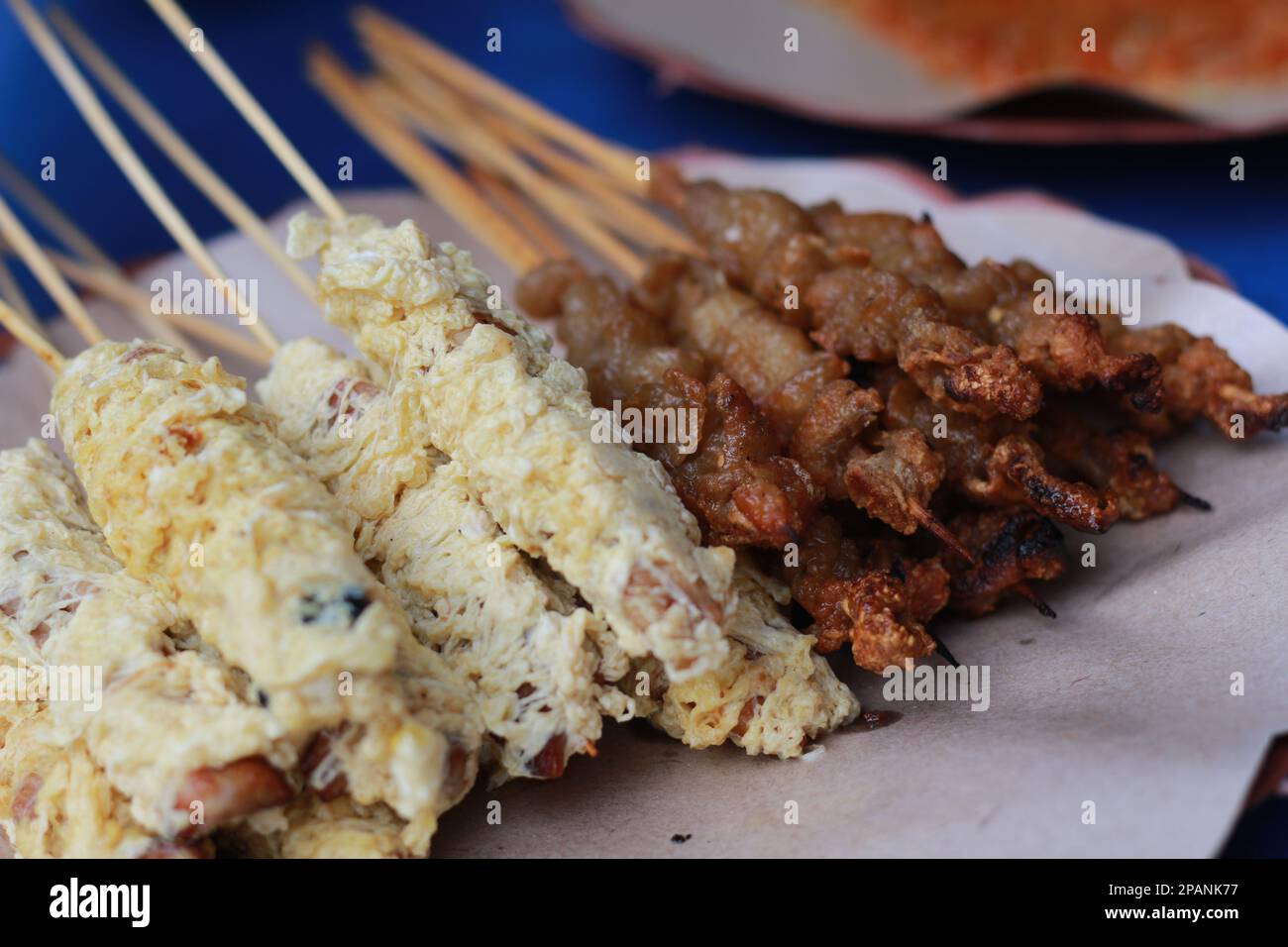 photo of chicken satay coated with fried egg and chicken intestine ...