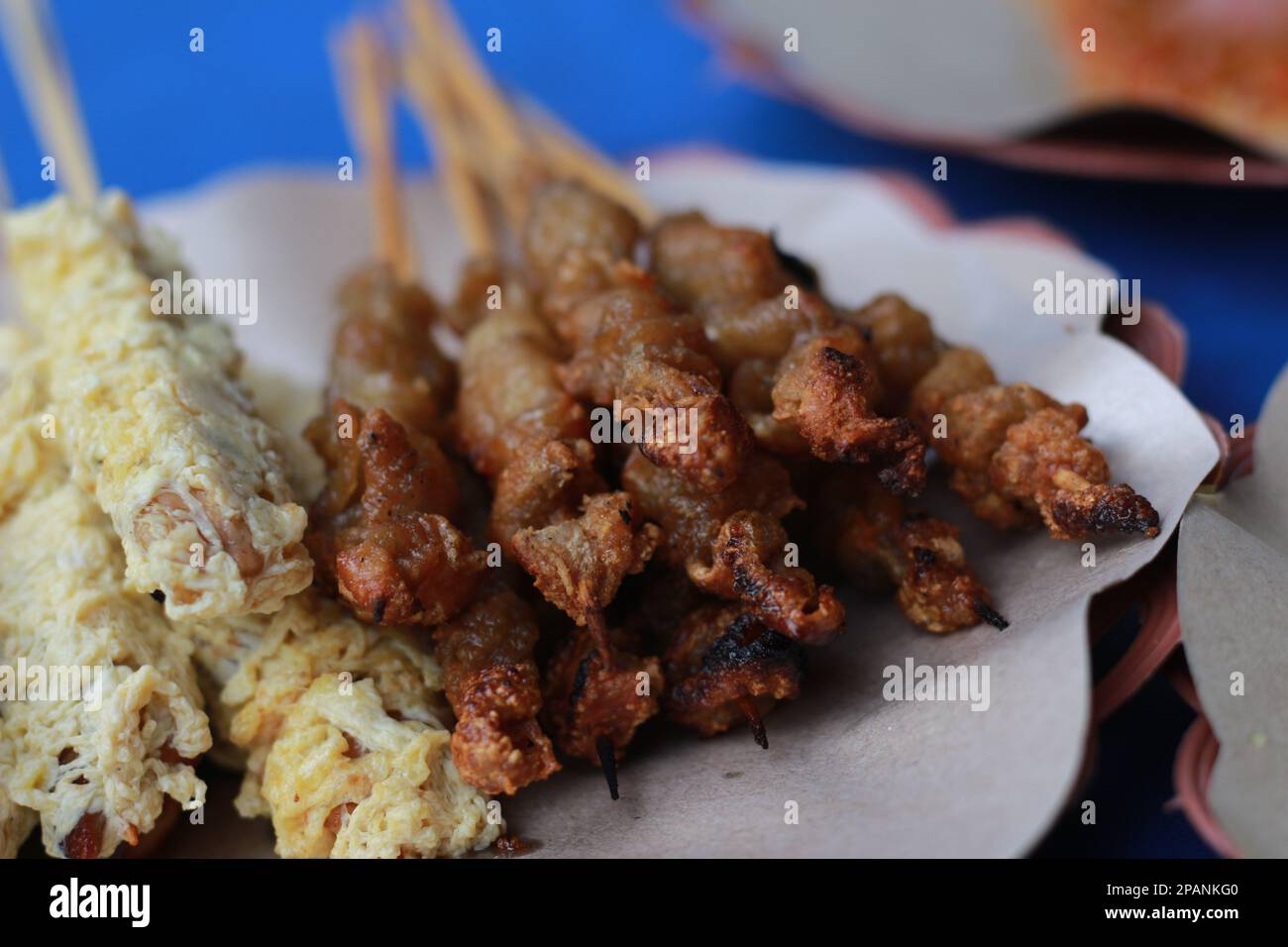 photo of chicken satay coated with fried egg and chicken intestine ...