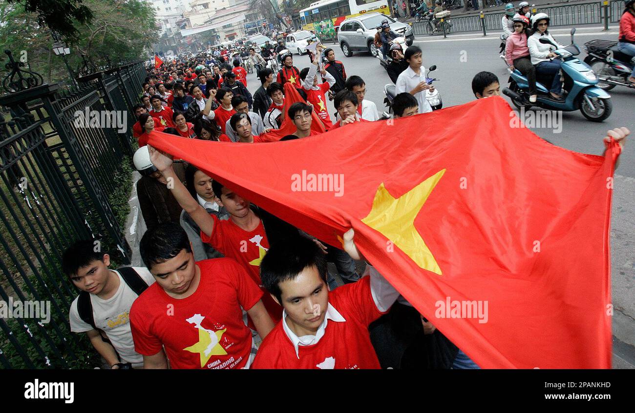 Vietnamese protesters walk through streets in downtown Hanoi, Vietnam ...