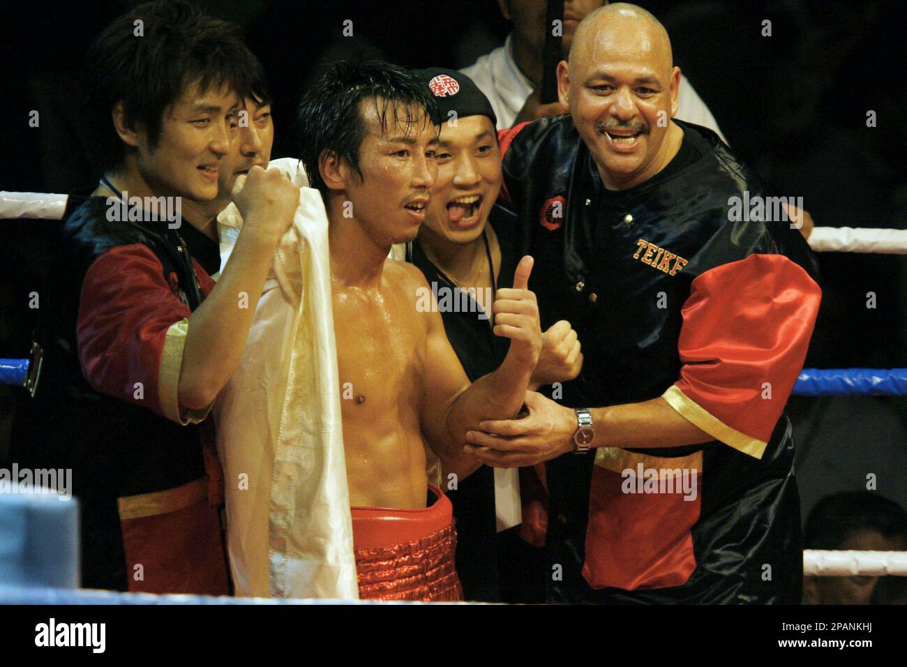 Naoki Matsuda of Japan, center, celebrates after winning a boxing match ...