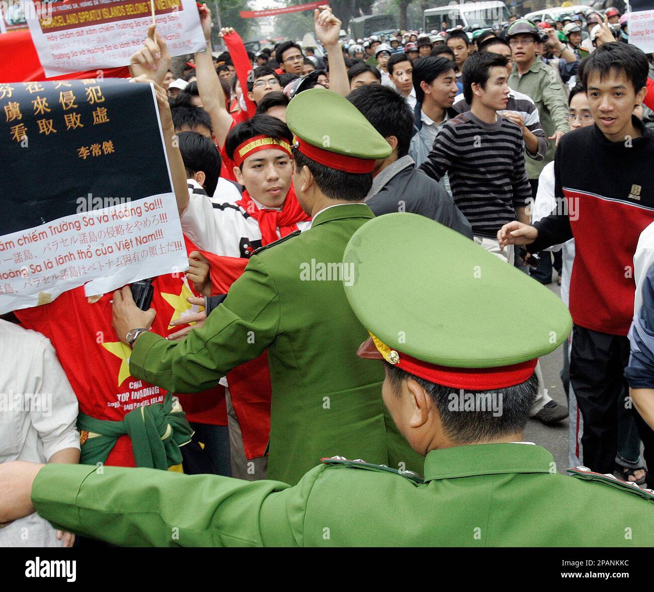 Vietnamese police officers push back Vietnamese protesters when they ...