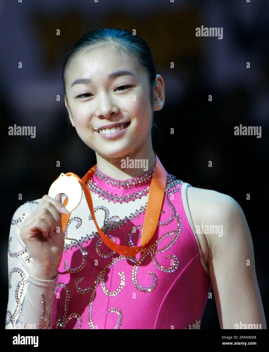 South Korea's Yu-Na Kim shows the gold medal on the podium after ...