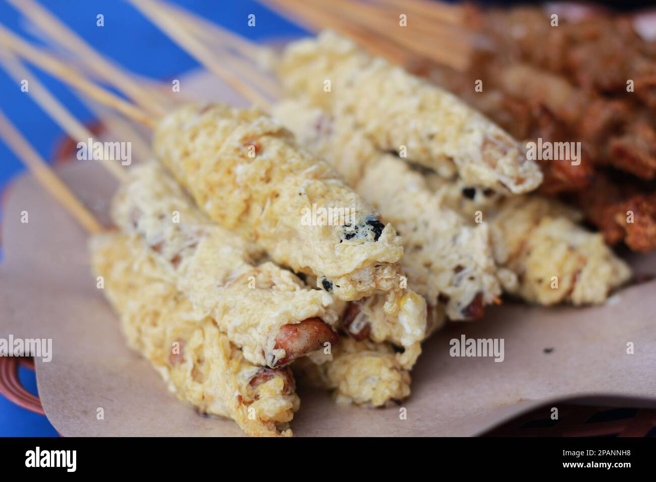 photo of chicken satay coated with fried egg and chicken intestine ...