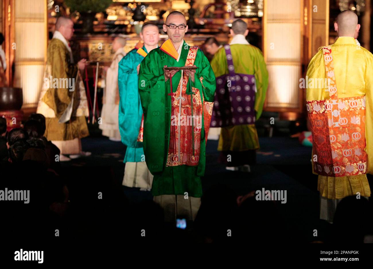Buddhist monks present display their robes before spectators during a ...