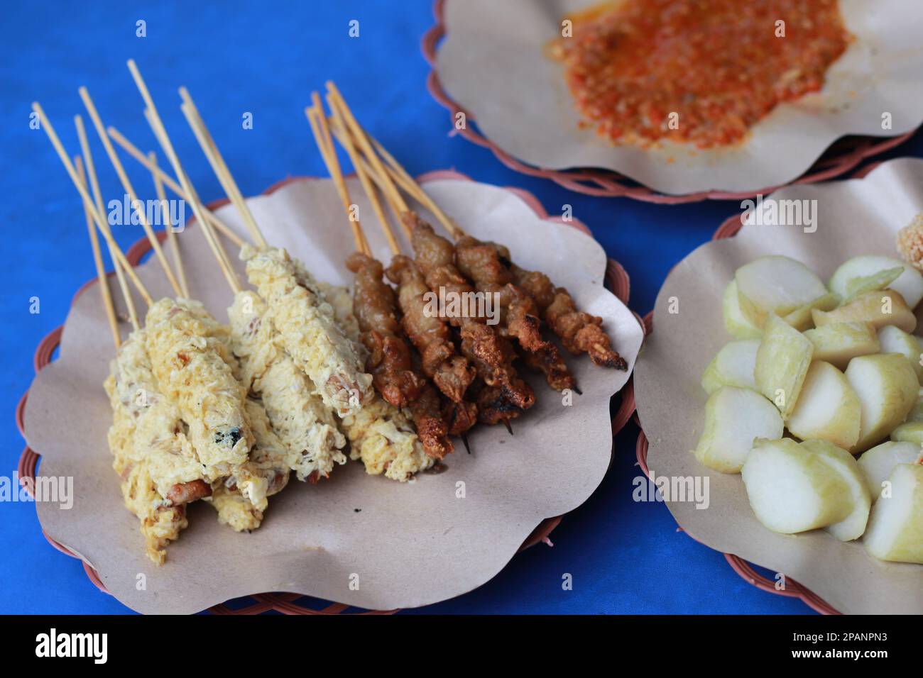 photo of chicken satay coated with fried egg and chicken intestine ...
