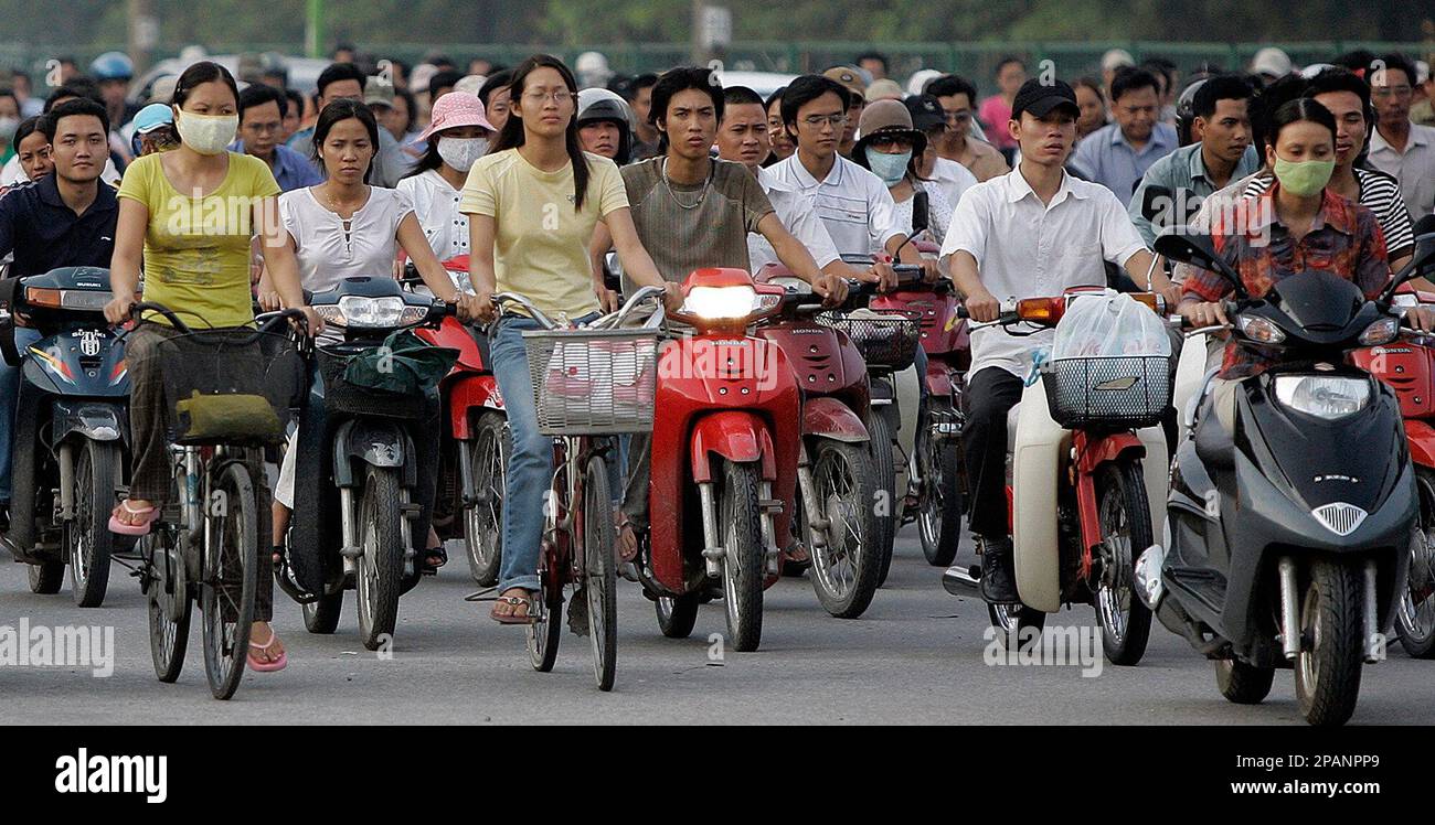 People ride motorcycles without helmets during rush hour in Hanoi ...