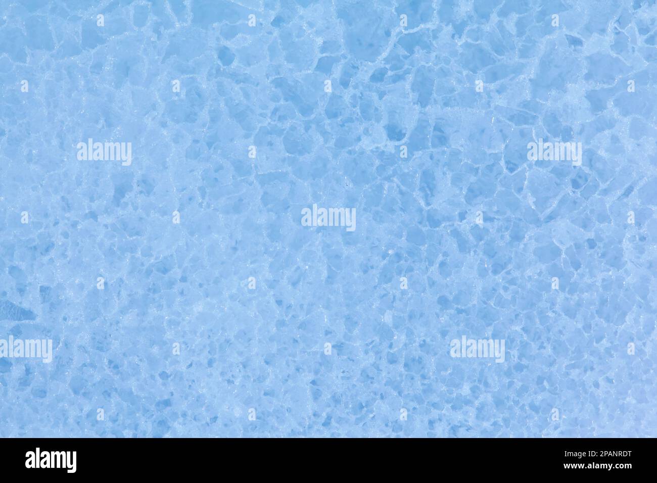 Texture of winter ice surface in the form of polygonal patterns. Blue ...