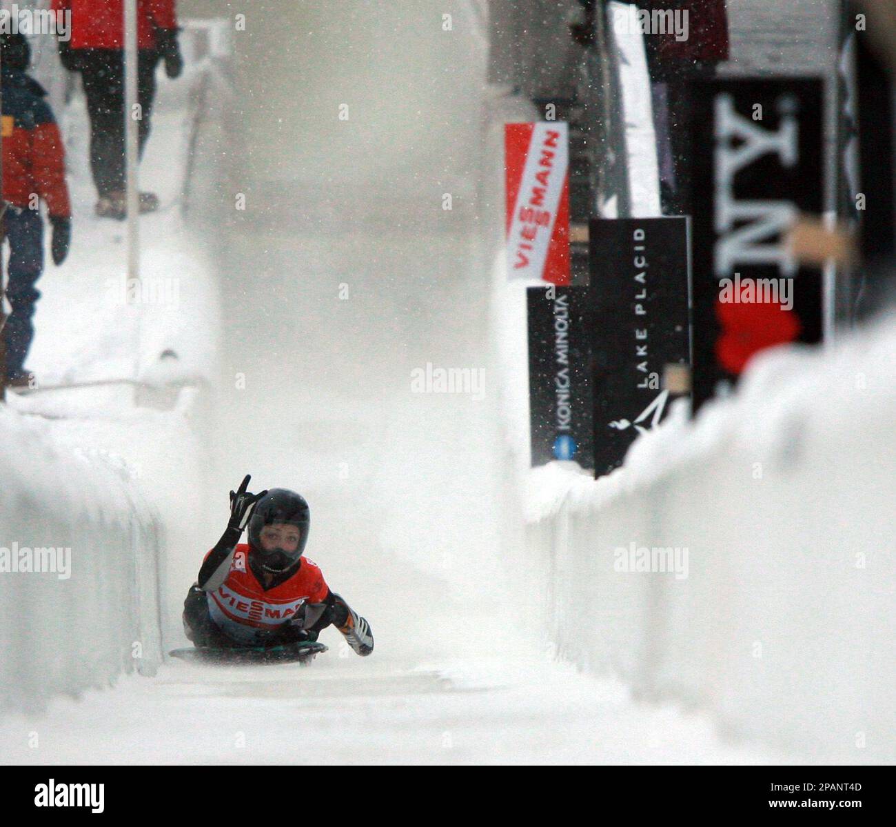 Katie Uhlaender, of the United States, signals the crowd after her ...