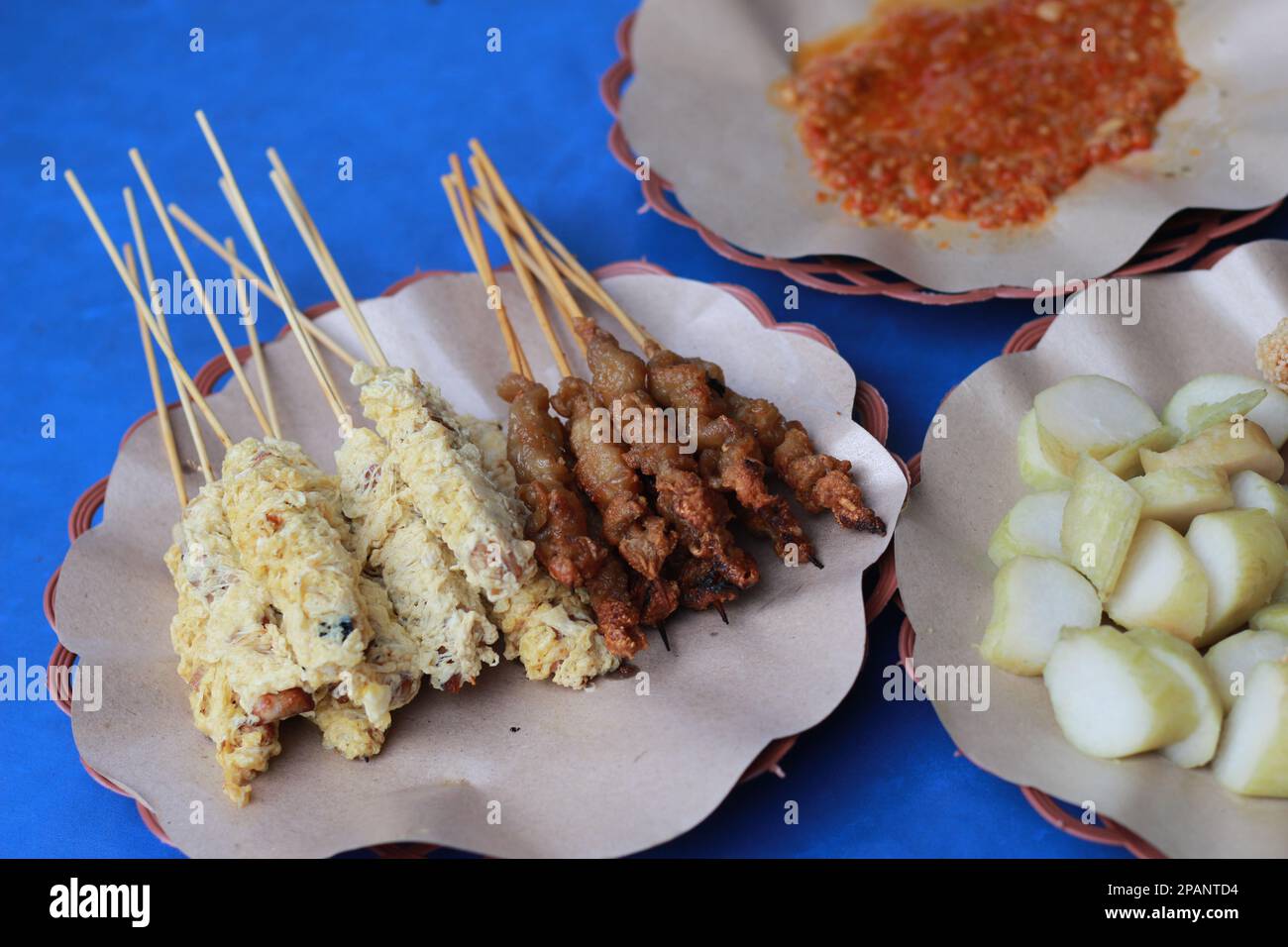 photo of chicken satay coated with fried egg and chicken intestine ...