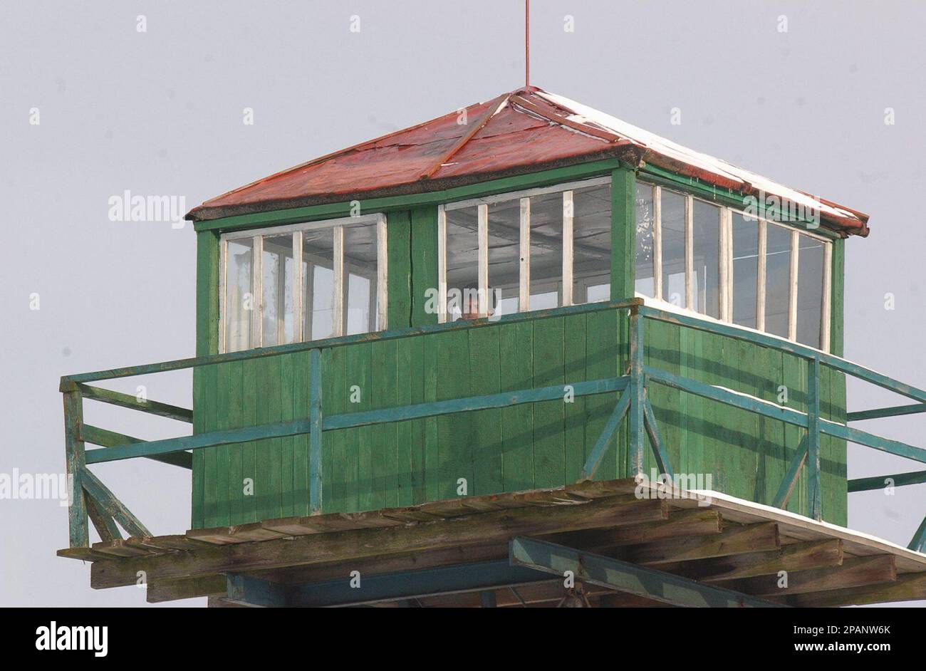 A Ukrainian border guard using a post Soviet watchtower, watches the ...