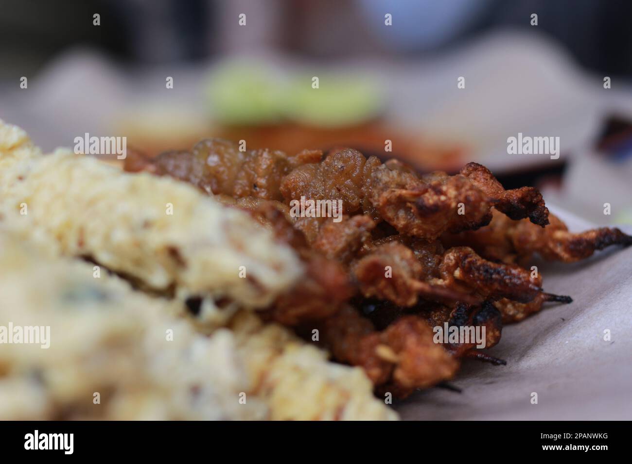 photo of chicken satay coated with fried egg and chicken intestine ...