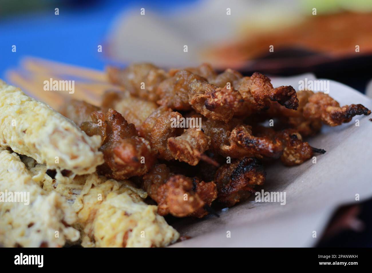 photo of chicken satay coated with fried egg and chicken intestine ...