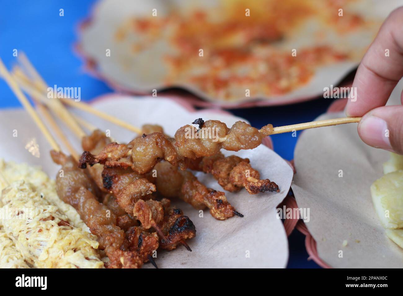photo of chicken intestine satay and served with red chili sauce ...