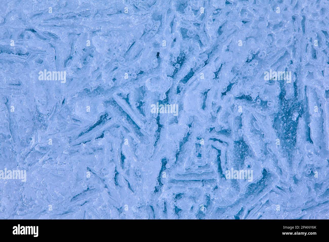 Texture of winter ice surface in the form of polygonal patterns. Blue ...