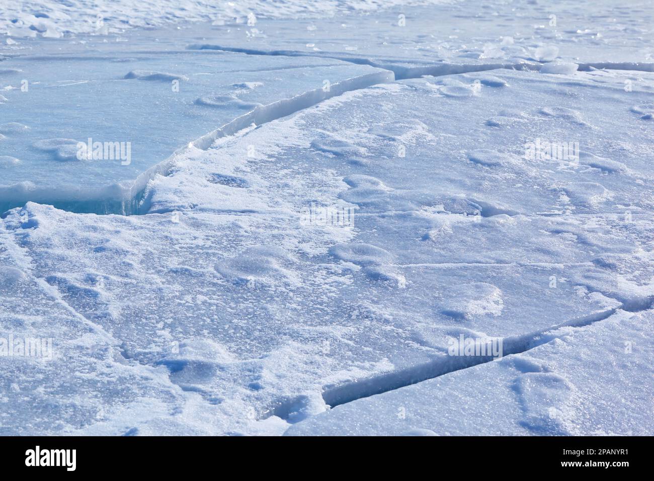 Winter ice landscape. Cracks in the ice field. Nanural winter ...