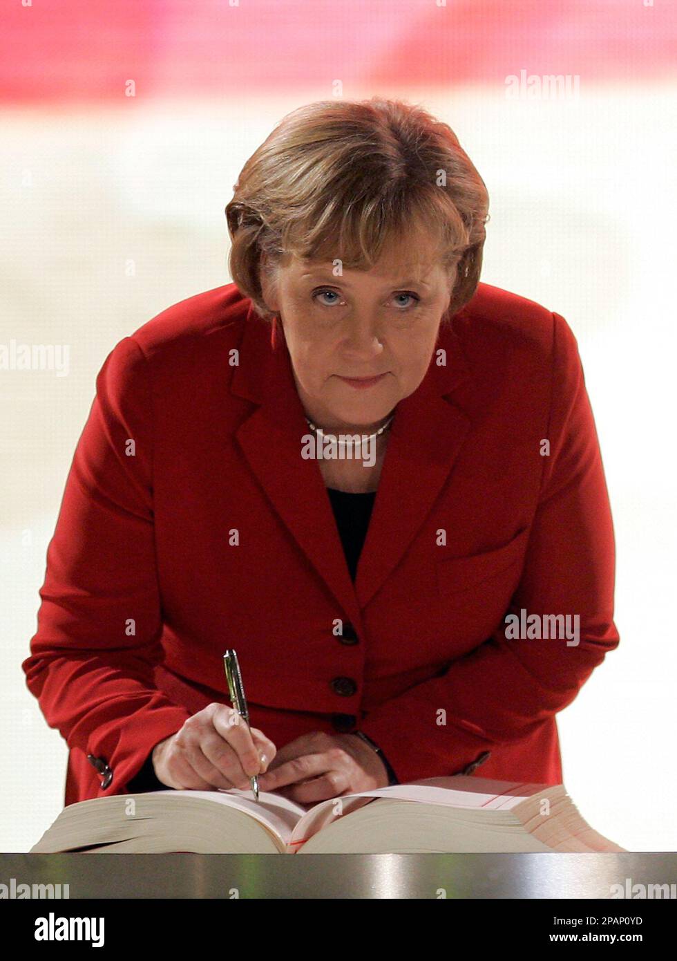 German Chancellor Angela Merkel signs the EU's Treaty of Lisbon during ...
