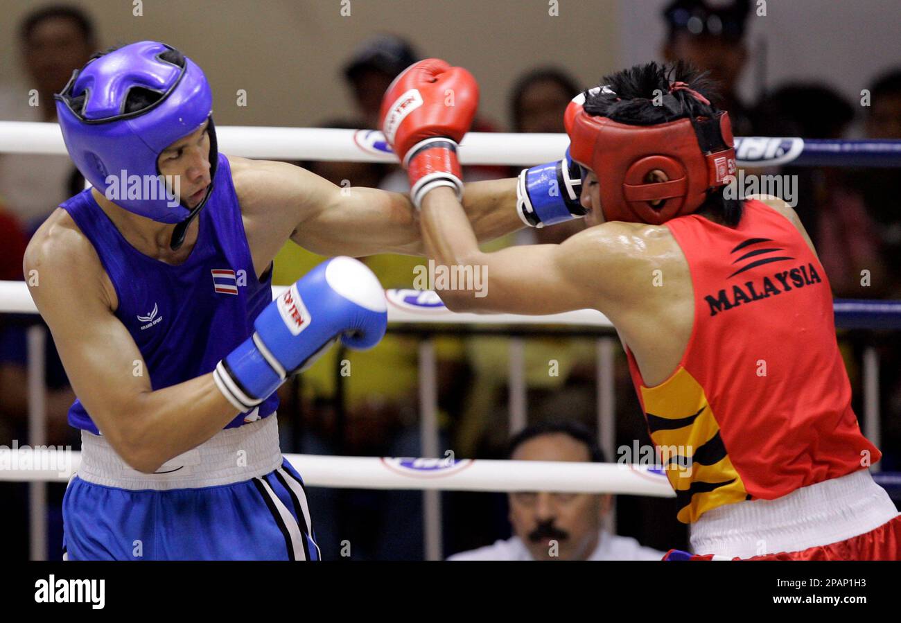 Thailand's Non Boojanong, left, lands a left to Malaysia's Mohamad ...