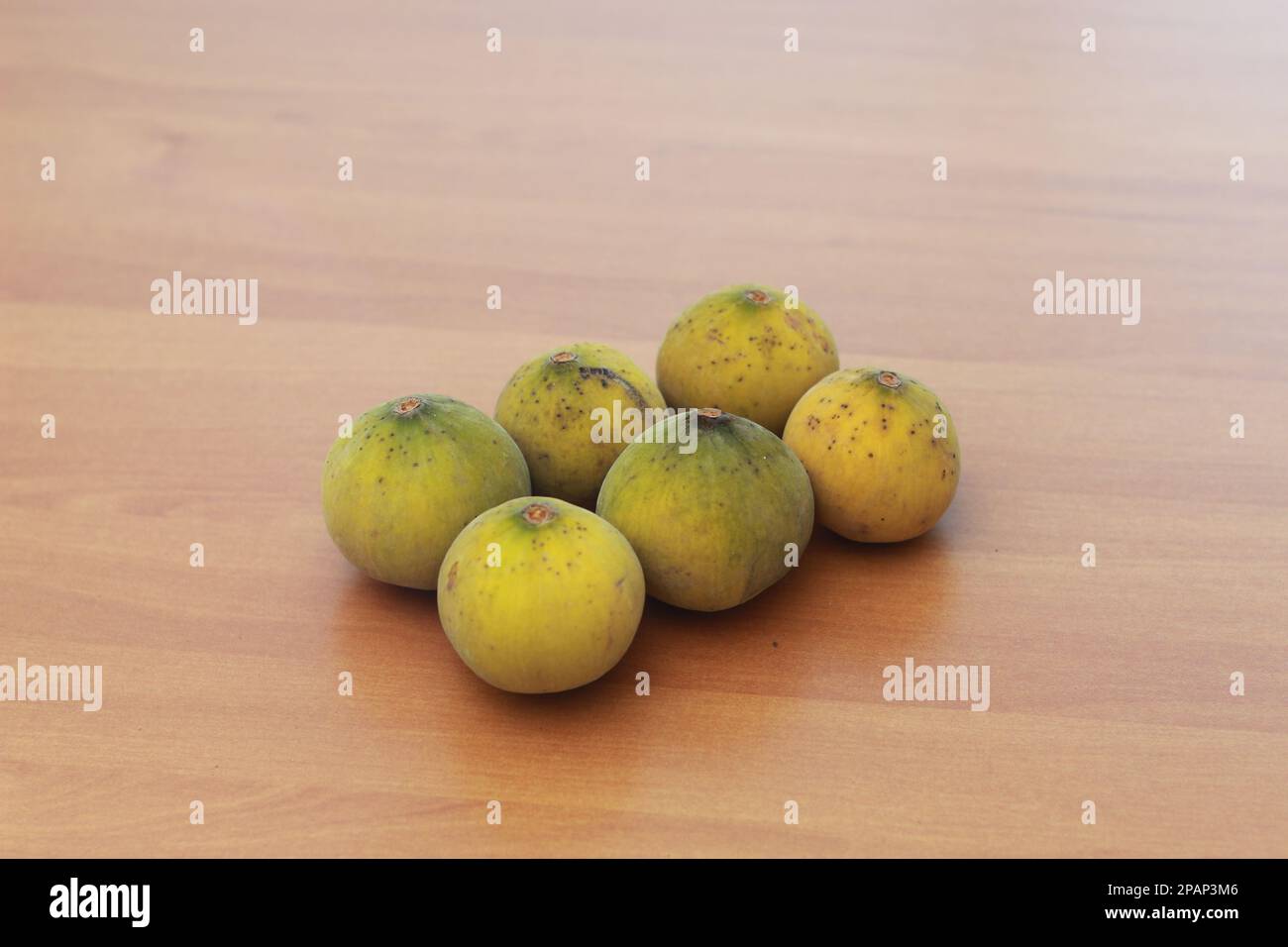 greenish yellow harp fruit isolated on money table has sweet and sour ...