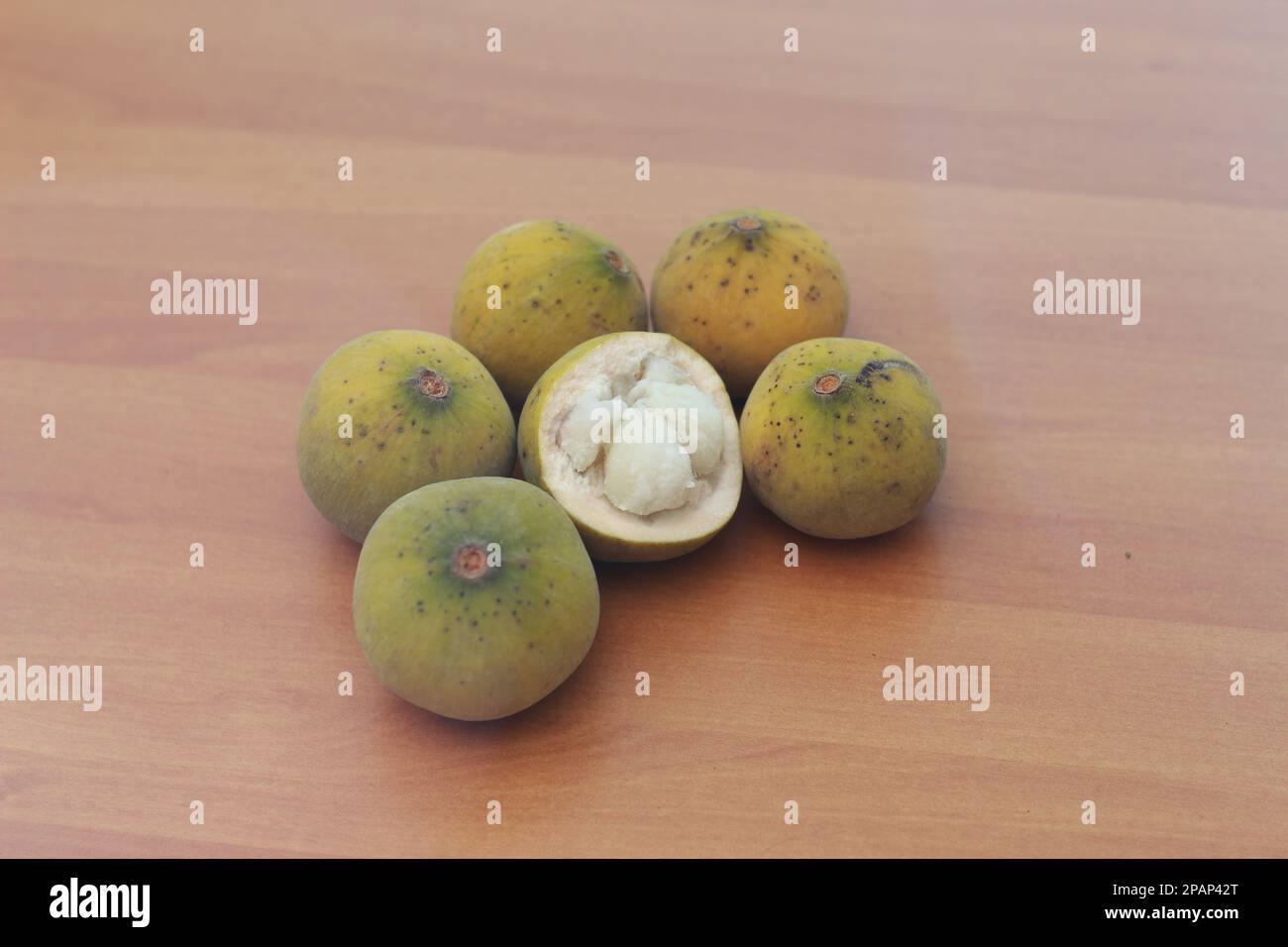 greenish yellow harp fruit isolated on money table has sweet and sour ...